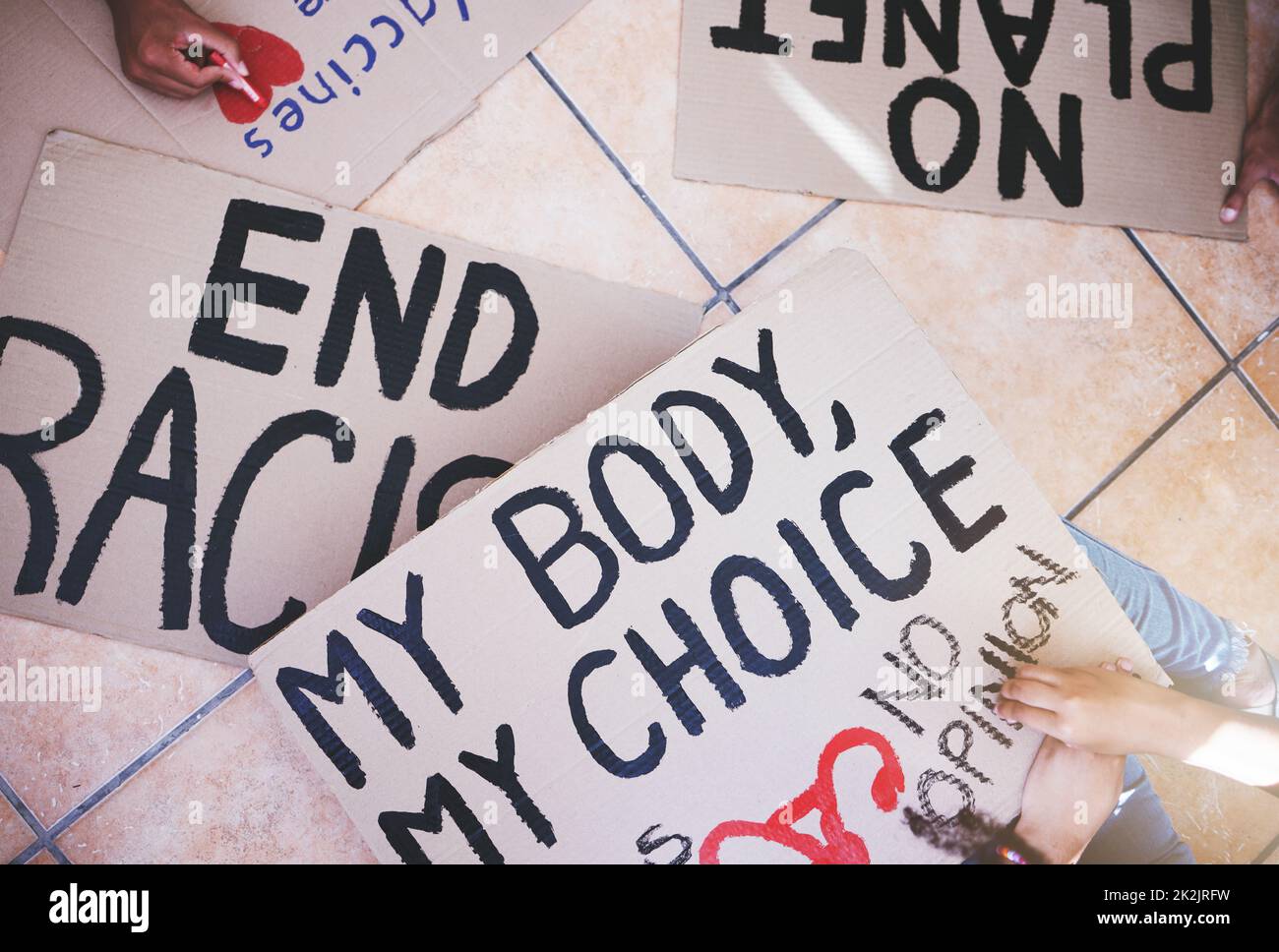 Writing on protest cardboard sign or banner for racism justice ...