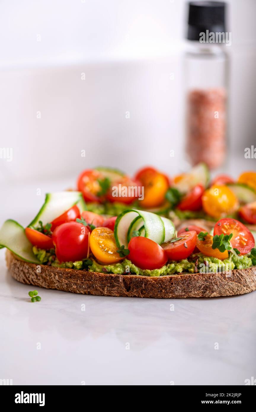 Toast with cherry tomatoes and avocado Stock Photo - Alamy