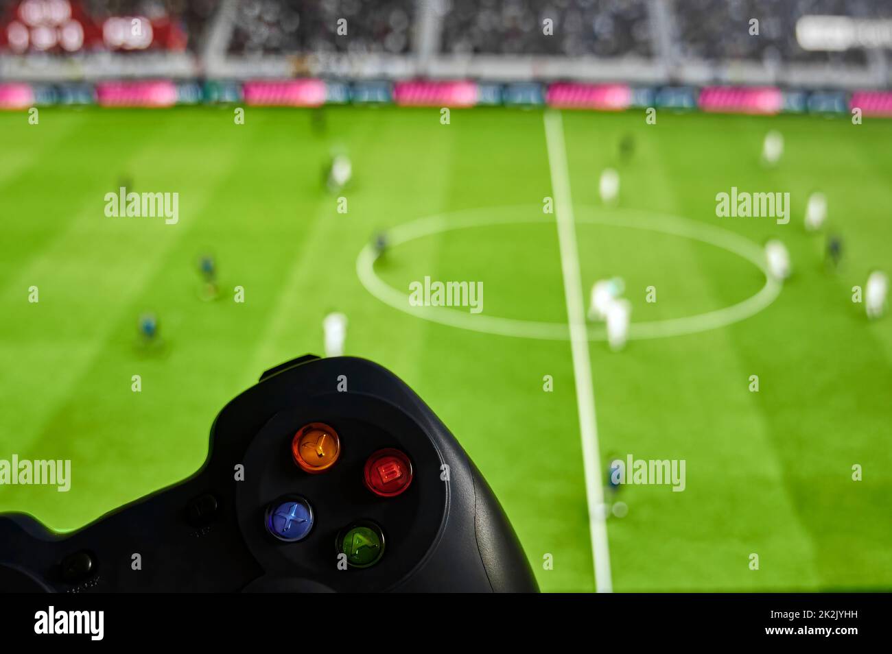 Game controller in front of a screen with a soccer video game Stock ...