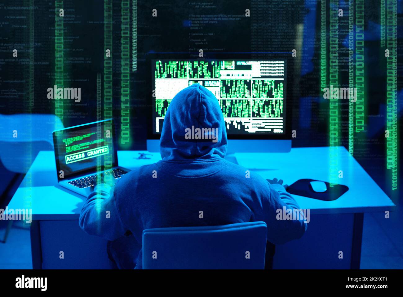 Easily breaching through your firewall. Rearview shot of a male hacker ...