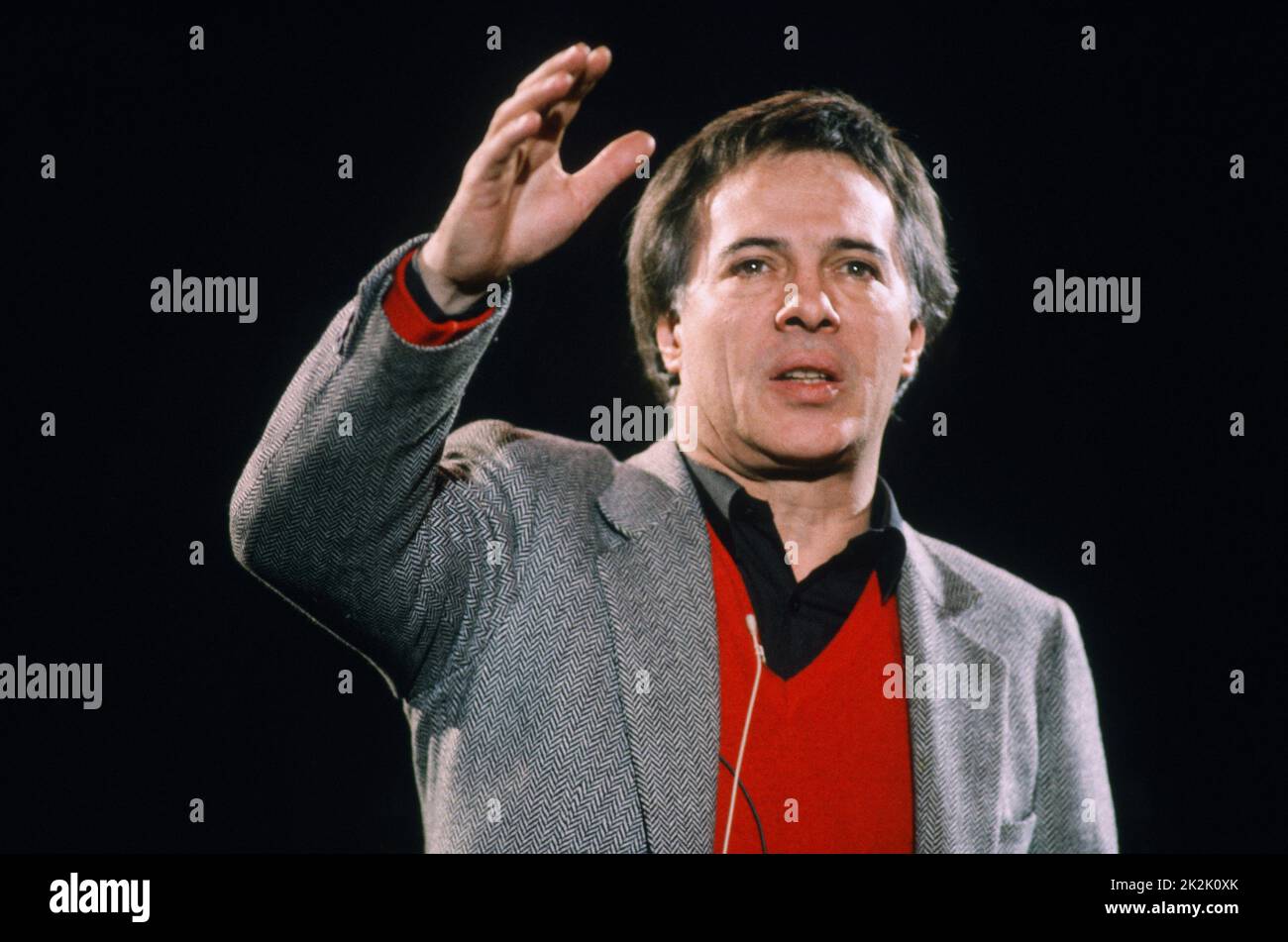 Portrait of French comedian Guy Bedos on stage, circa 1986 Stock Photo ...