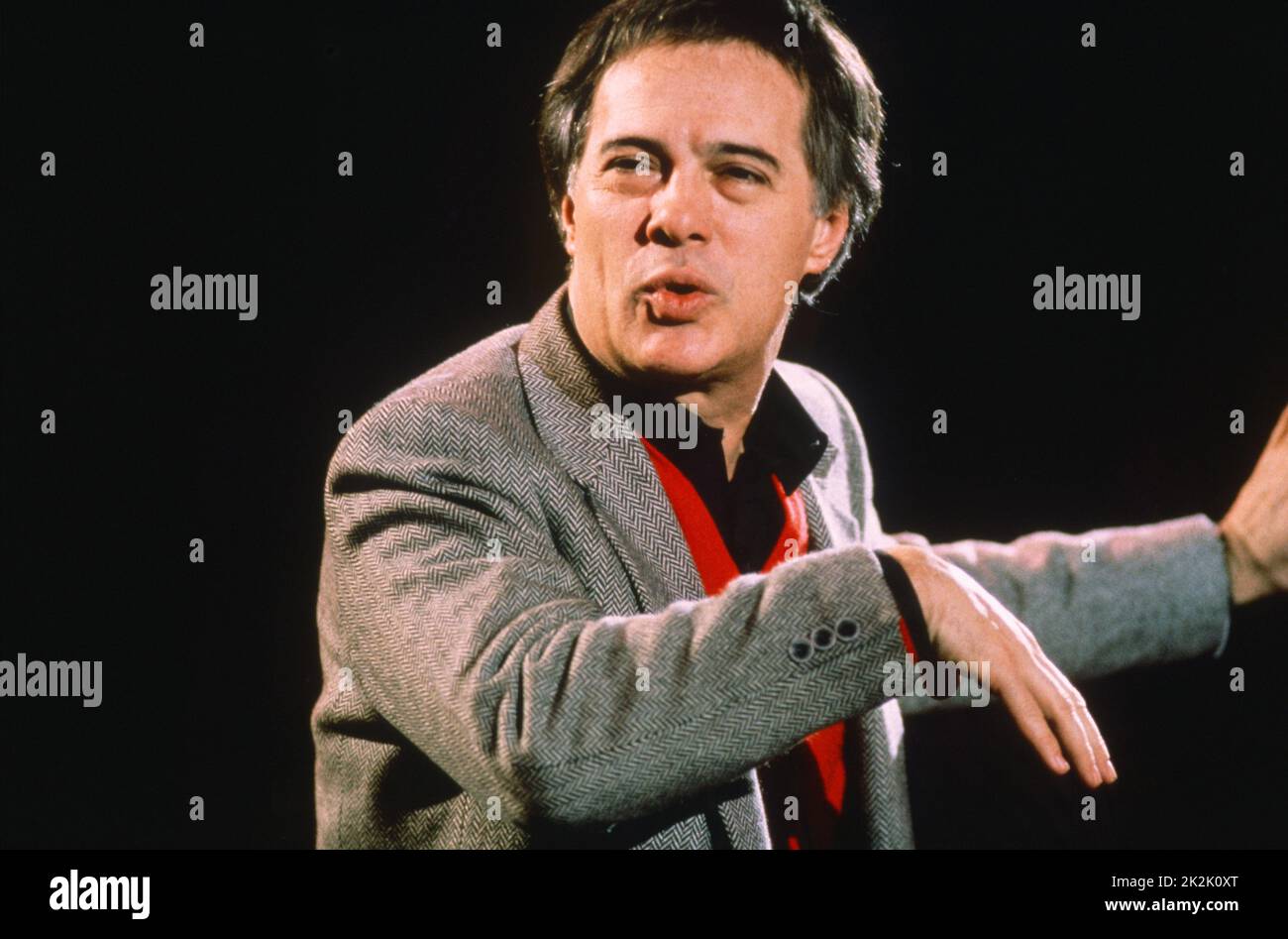 Portrait of French comedian Guy Bedos on stage, circa 1986 Stock Photo ...