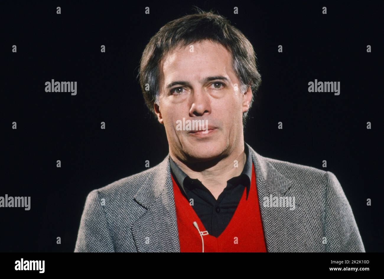Portrait of French comedian Guy Bedos on stage, circa 1986 Stock Photo ...