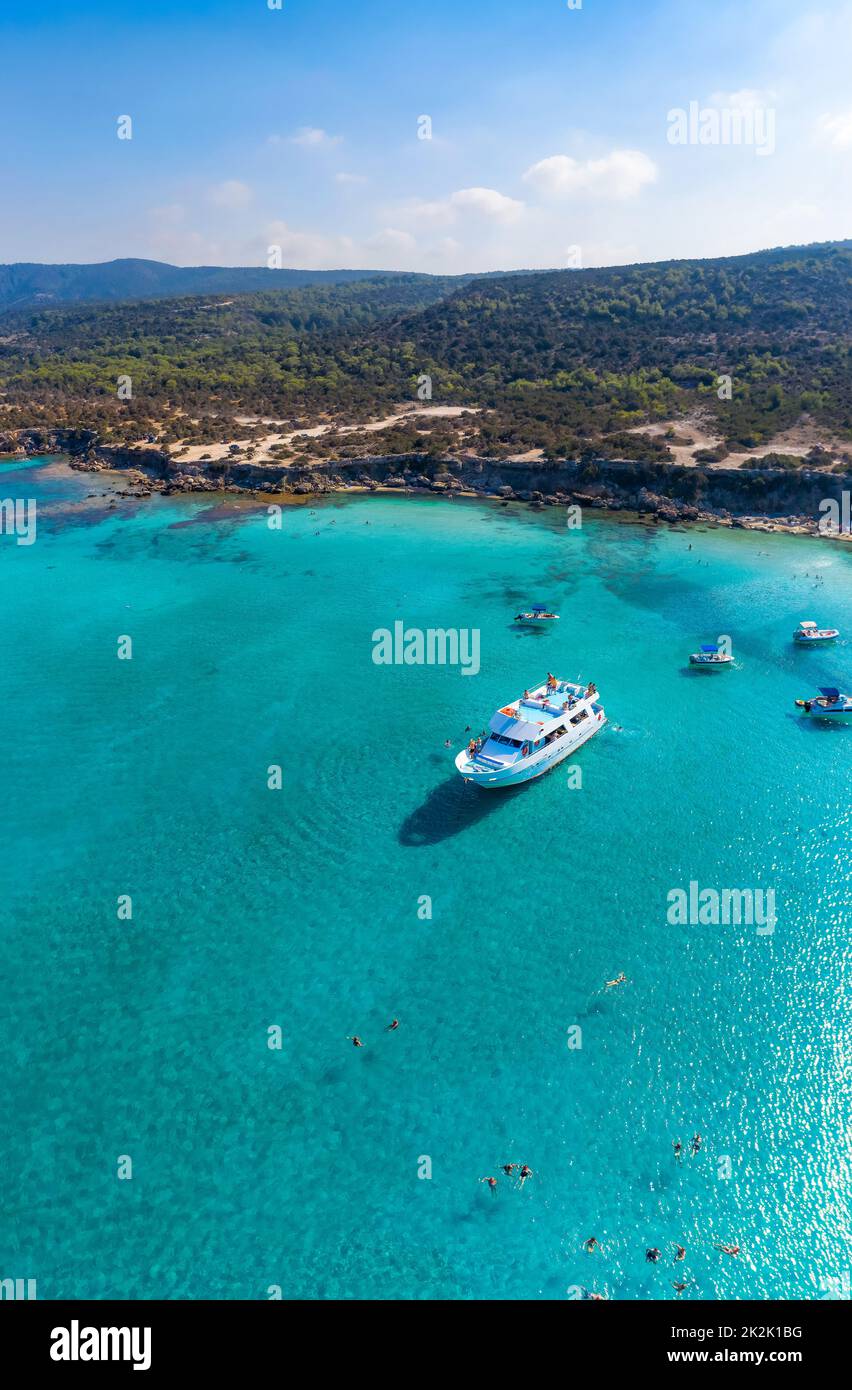 Excursion boat with tourists in lagoon near Latchi village. Paphos ...