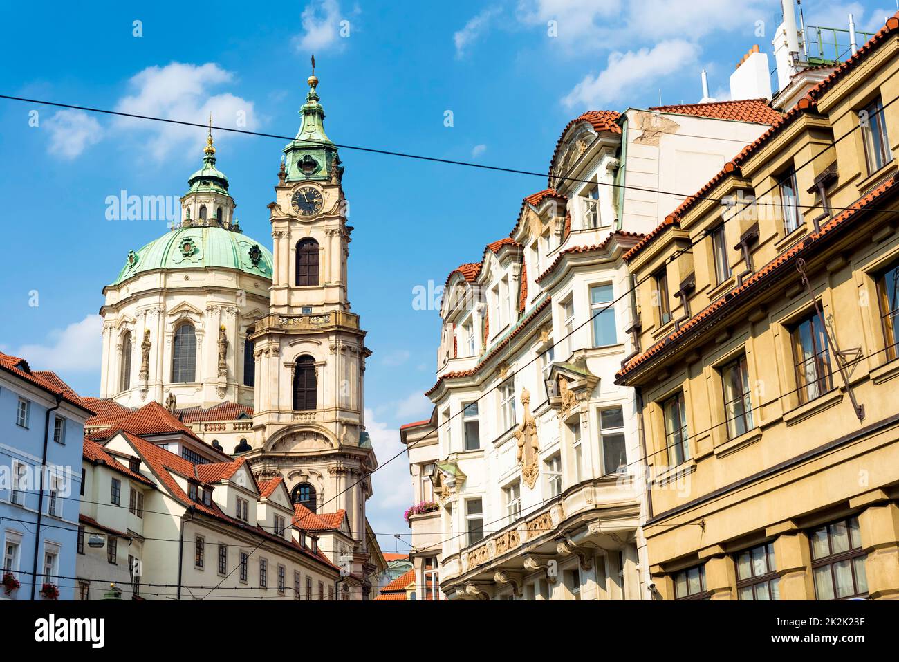 St. Nicholas Church rising up between the narrow streets. Prague, Czech ...