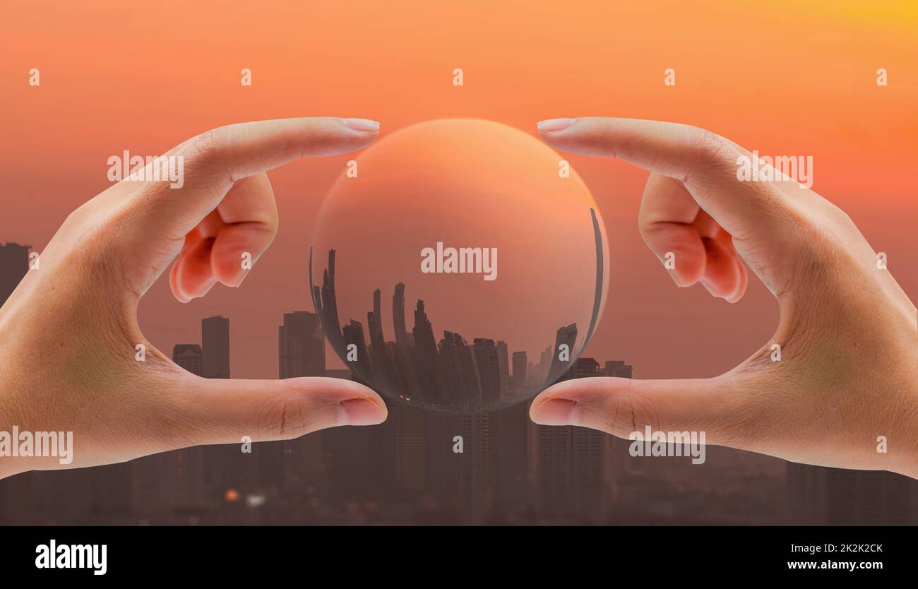 Human hand holding building in the city with air pollution. Carbon ...