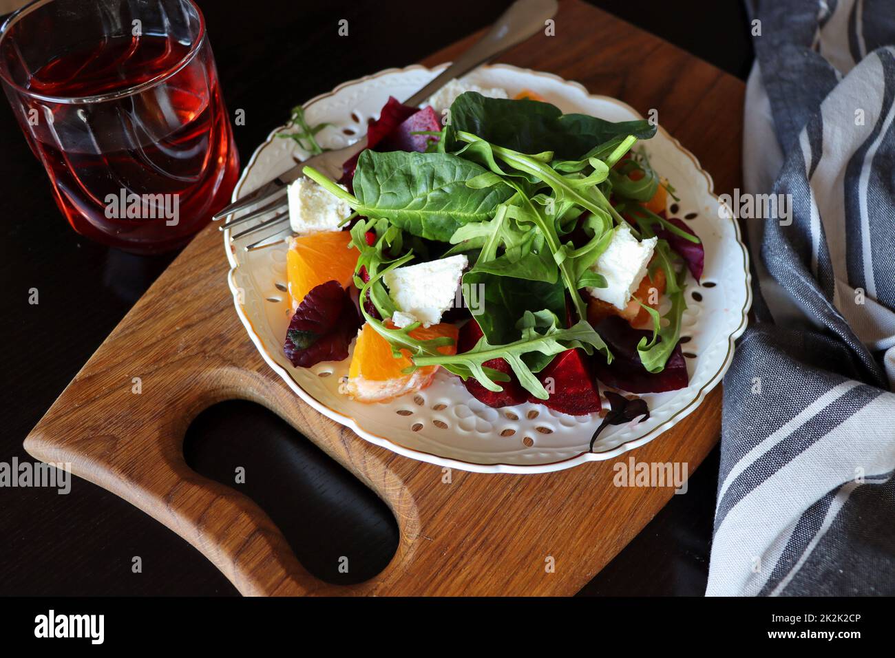 Salad with beetroot, arugula,feta cheese, orange, spinach on gray ...