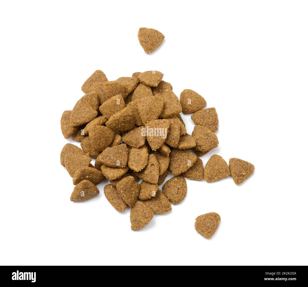 triangular pieces of animal food on a white background. Pile of ...