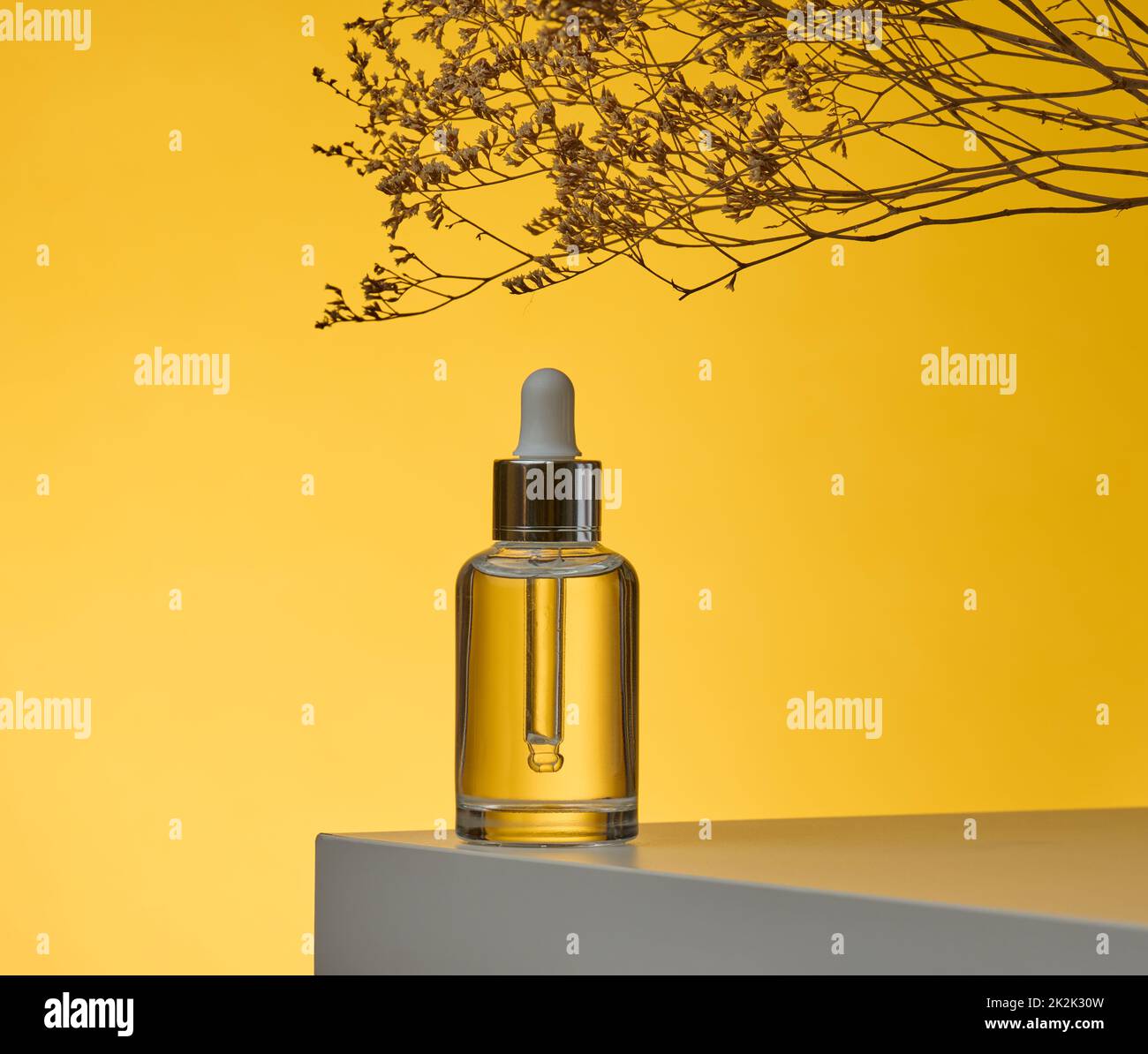 white glass transparent bottle with a pipette for cosmetics, oils ...