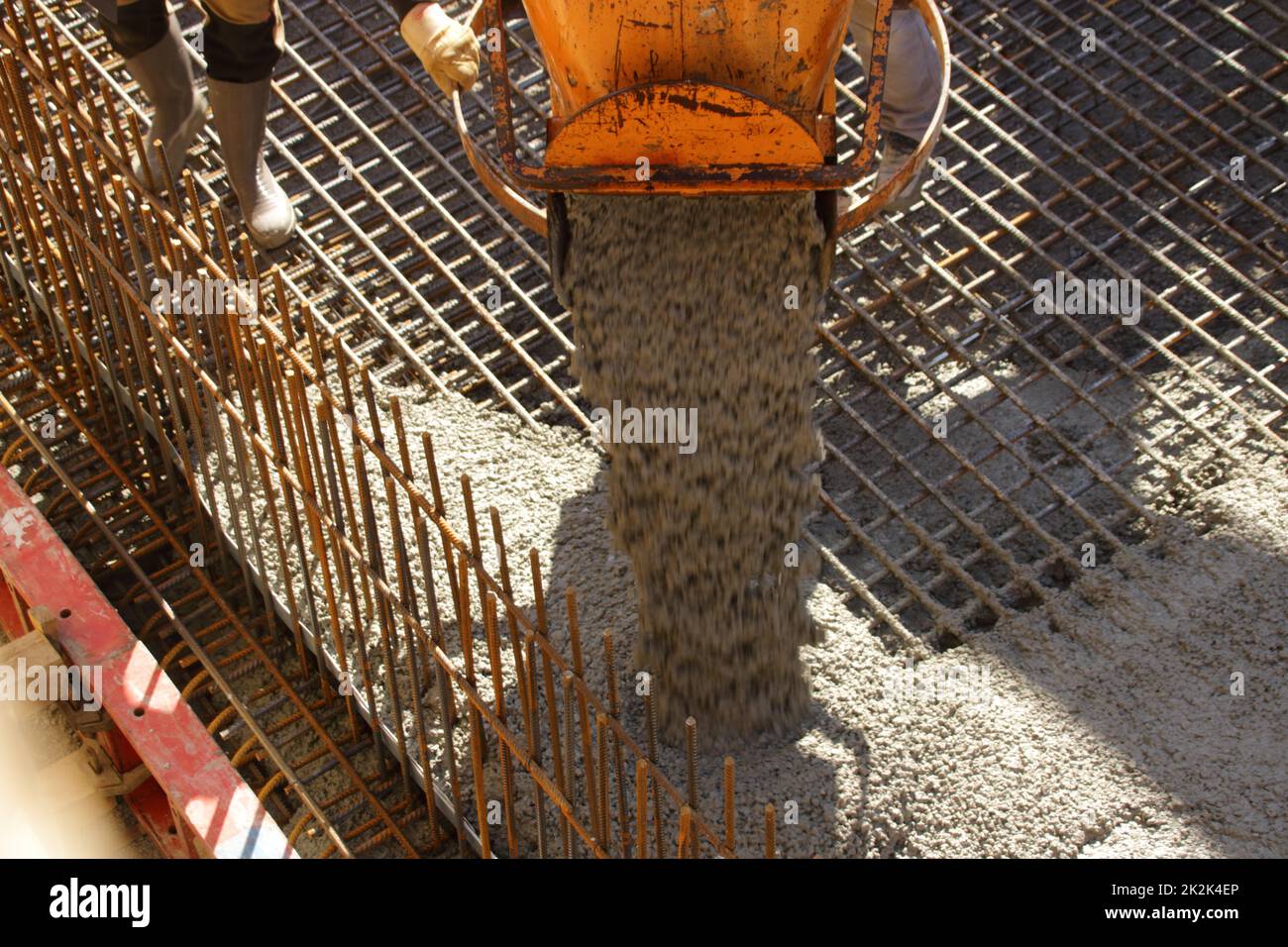 Filling up a foundation with concrete through a silo Stock Photo - Alamy