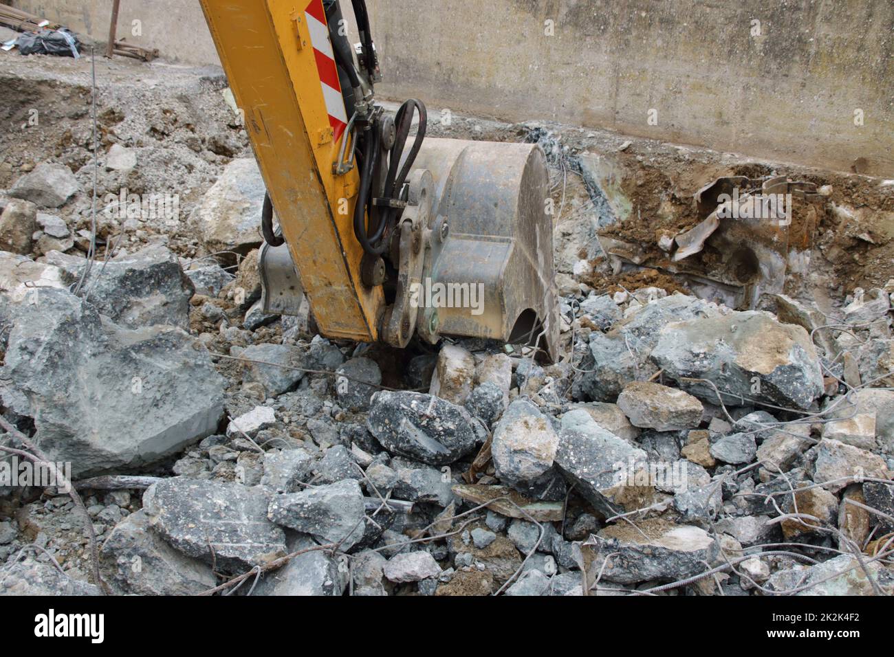 Loading construction rubble with an excavator in a dusty environment ...
