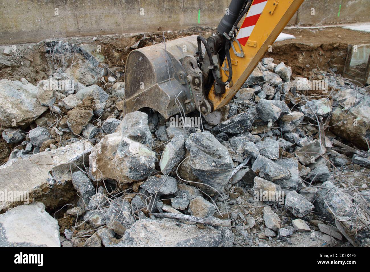 Loading construction rubble with an excavator in a dusty environment ...