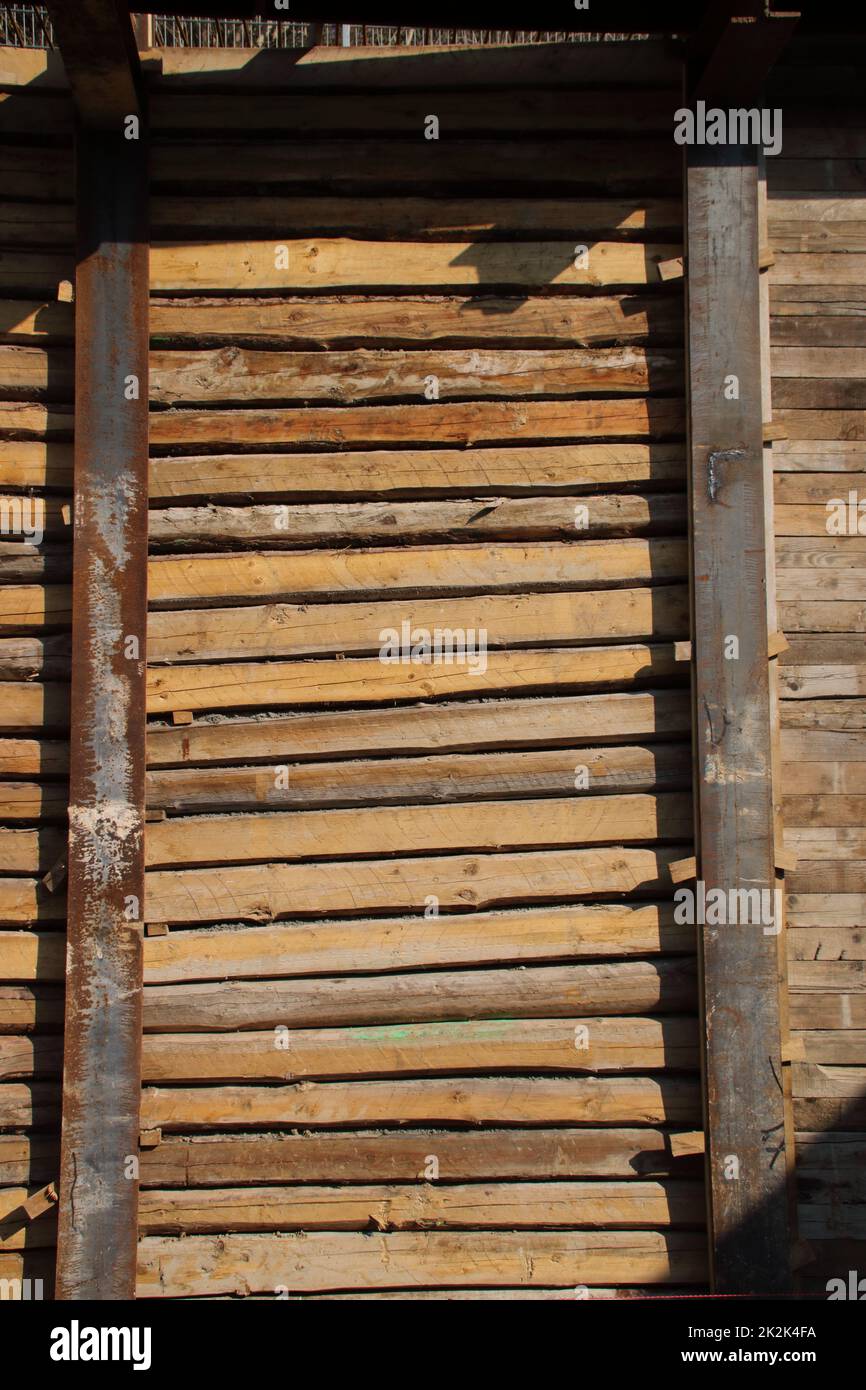 Excavation pit is secured against collapsing with iron girders and ...