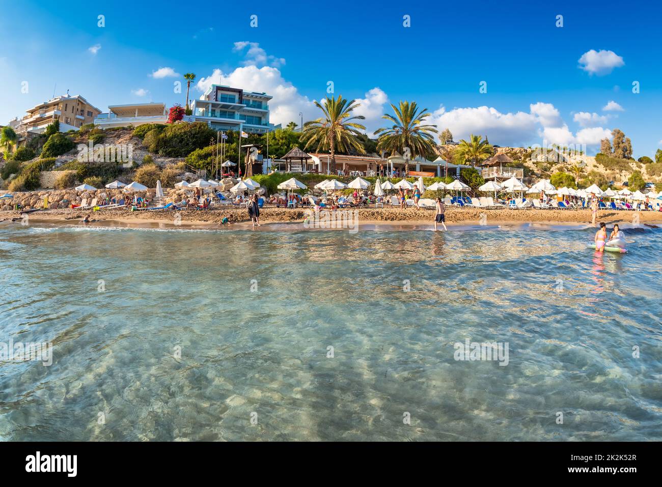 People relaxing on Coral Bay Beach, one of the most famous beaches in ...