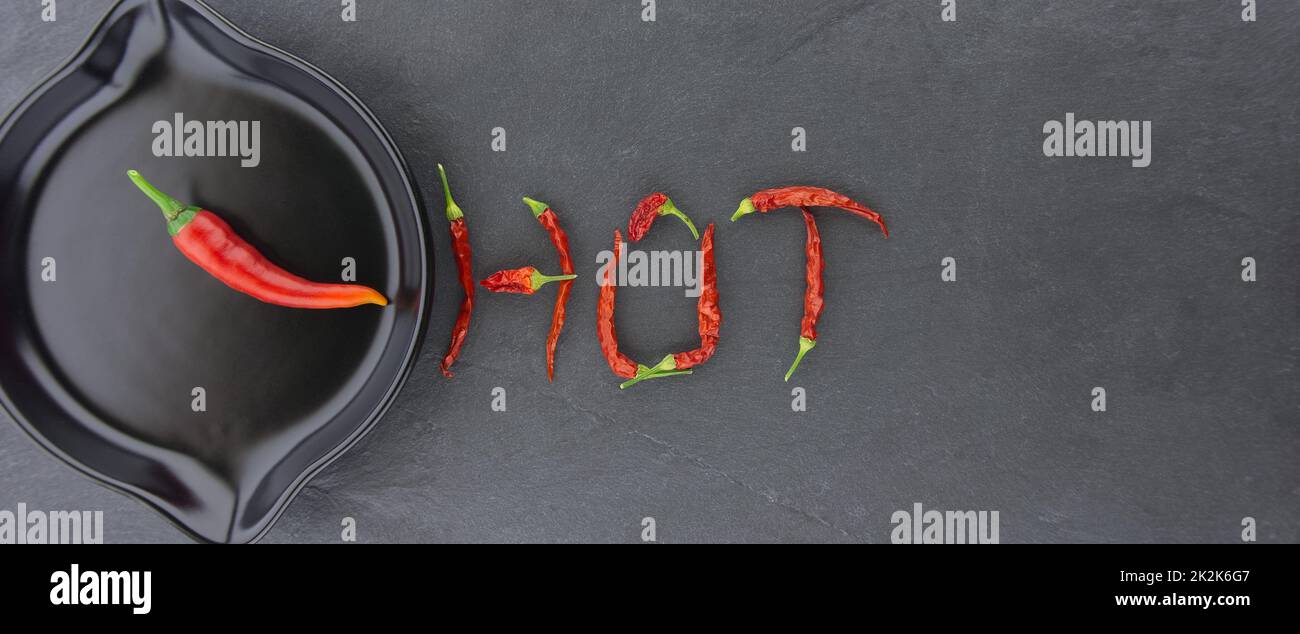 HOT spicy chili pepper still life with text Stock Photo - Alamy