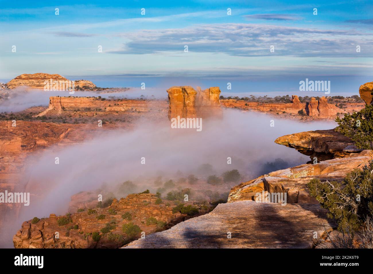 Low clouds flow off the mesa top into the Green River Basin during a ...