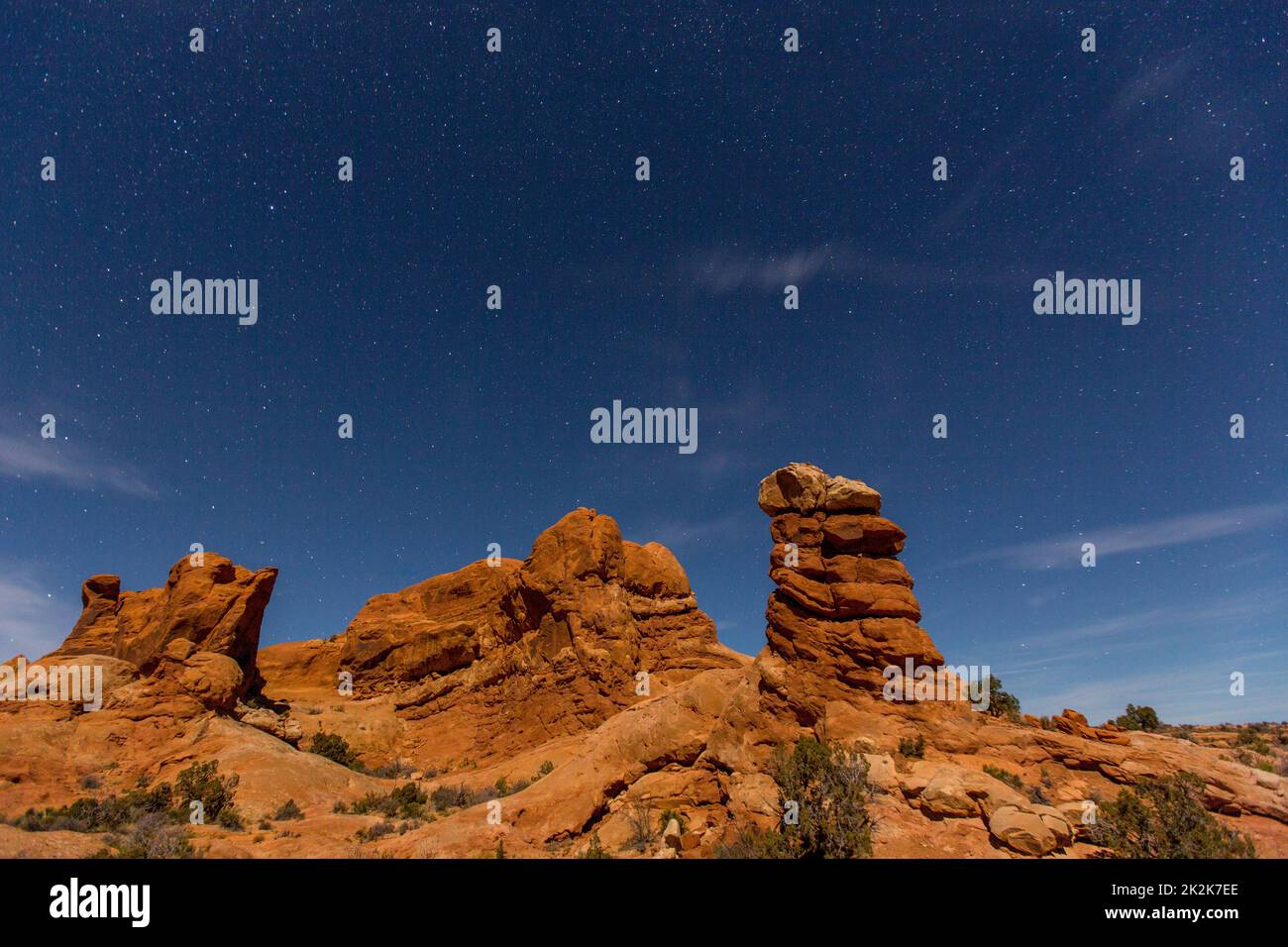 Stars over an Entrada sandstone rock spire by moonlight at night in ...