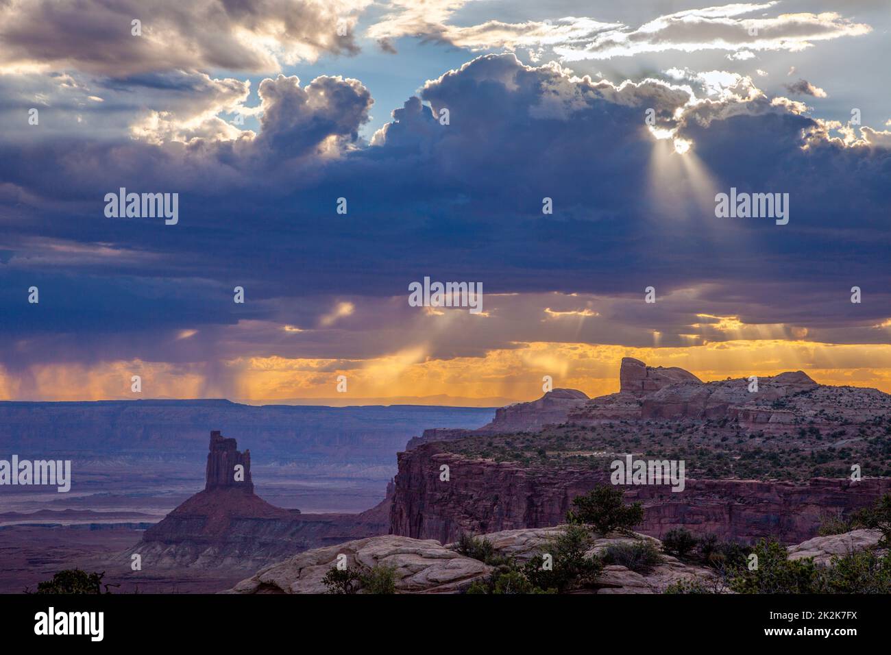 Stormy skies at sunset over the Candlestick Tower in Canyonlands ...