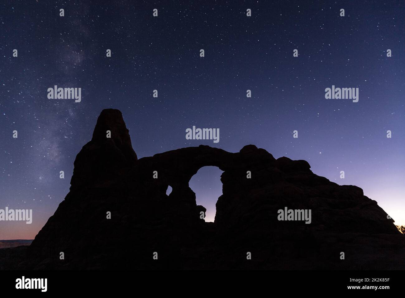 A faint Milky Way Galaxy at twilight over Turret Arch in the Windows ...