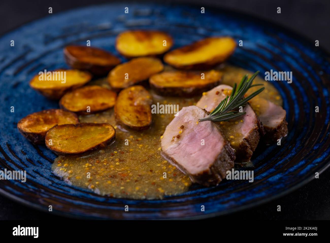 pork tenderloin with baked potatoes and French coarse mustard sauce ...