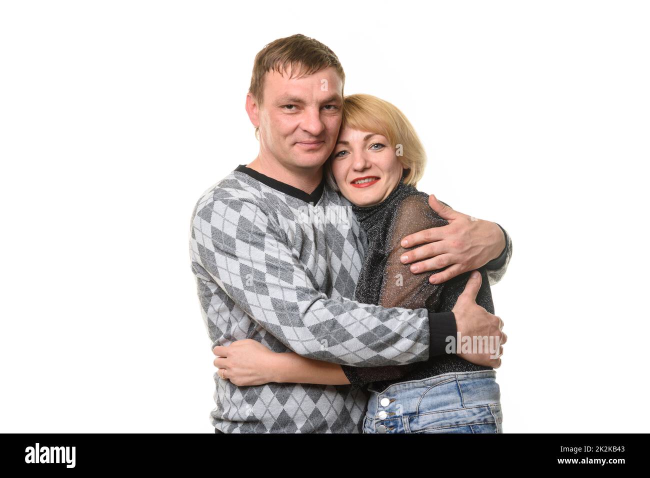 Man and woman hugging and looking into the frame, isolated on a white ...