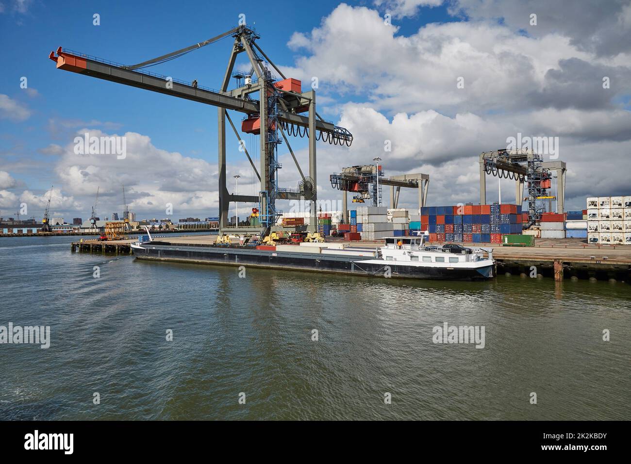 Loading containers on a ship Stock Photo - Alamy
