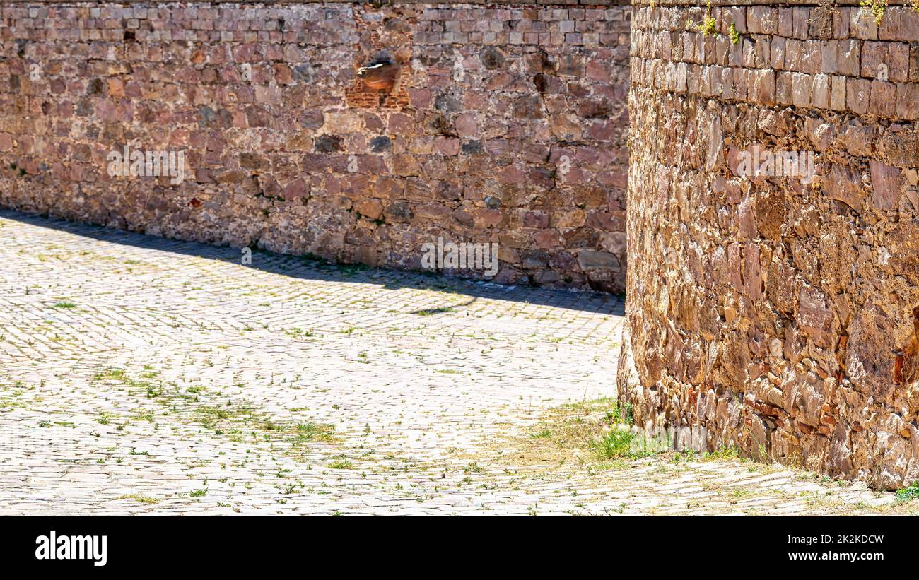 Montjuic Castle or Fort. Cobblestone street and stone walls in the ...