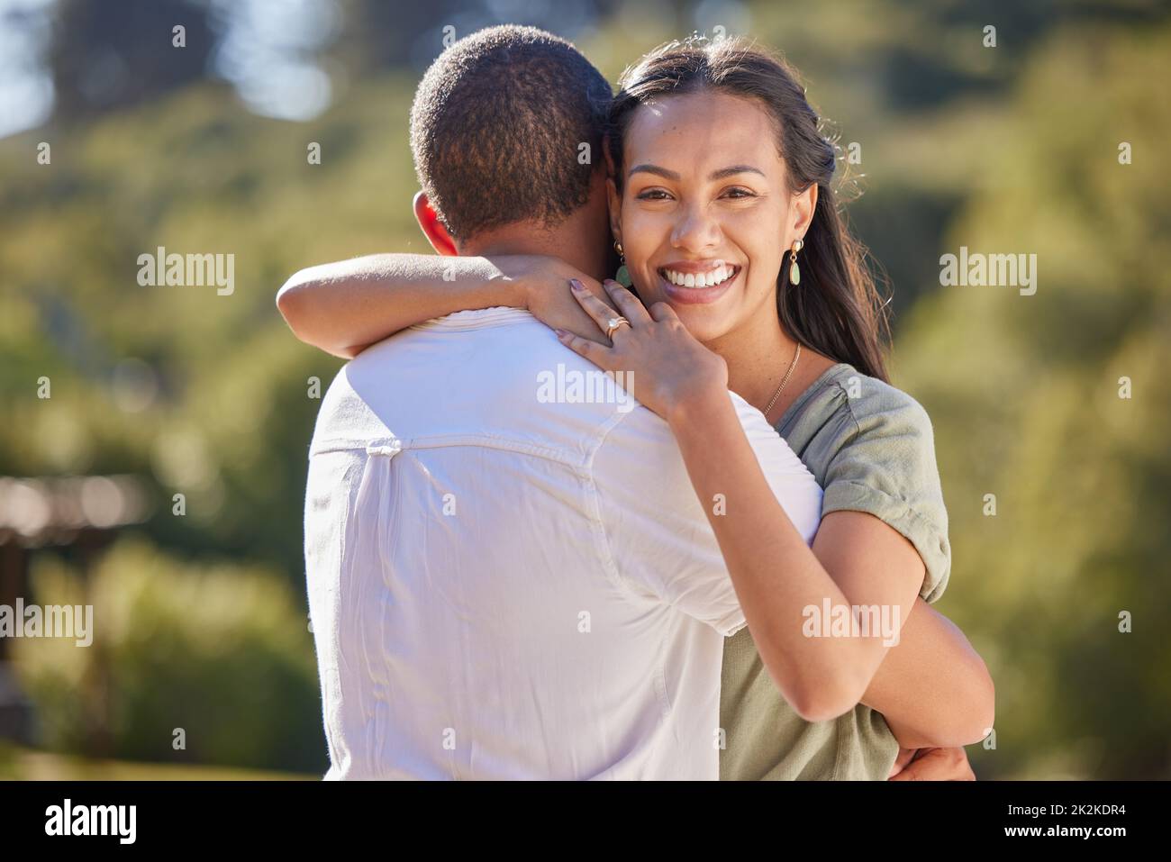 Couple, love bond and hug after an engagement with wedding ring ...
