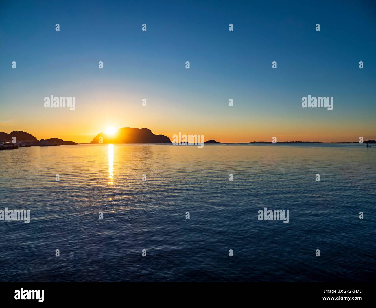 Beautiful sunset behind a rocky island on the Norwegian coast Stock ...