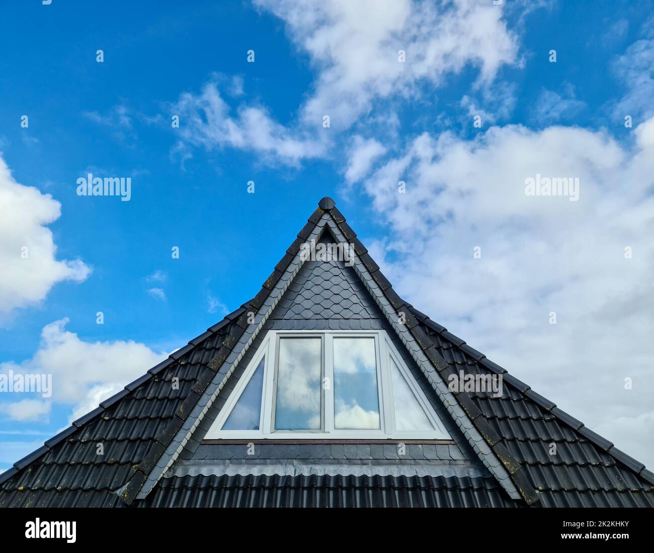 Open roof window in velux style with black roof tiles Stock Photo - Alamy
