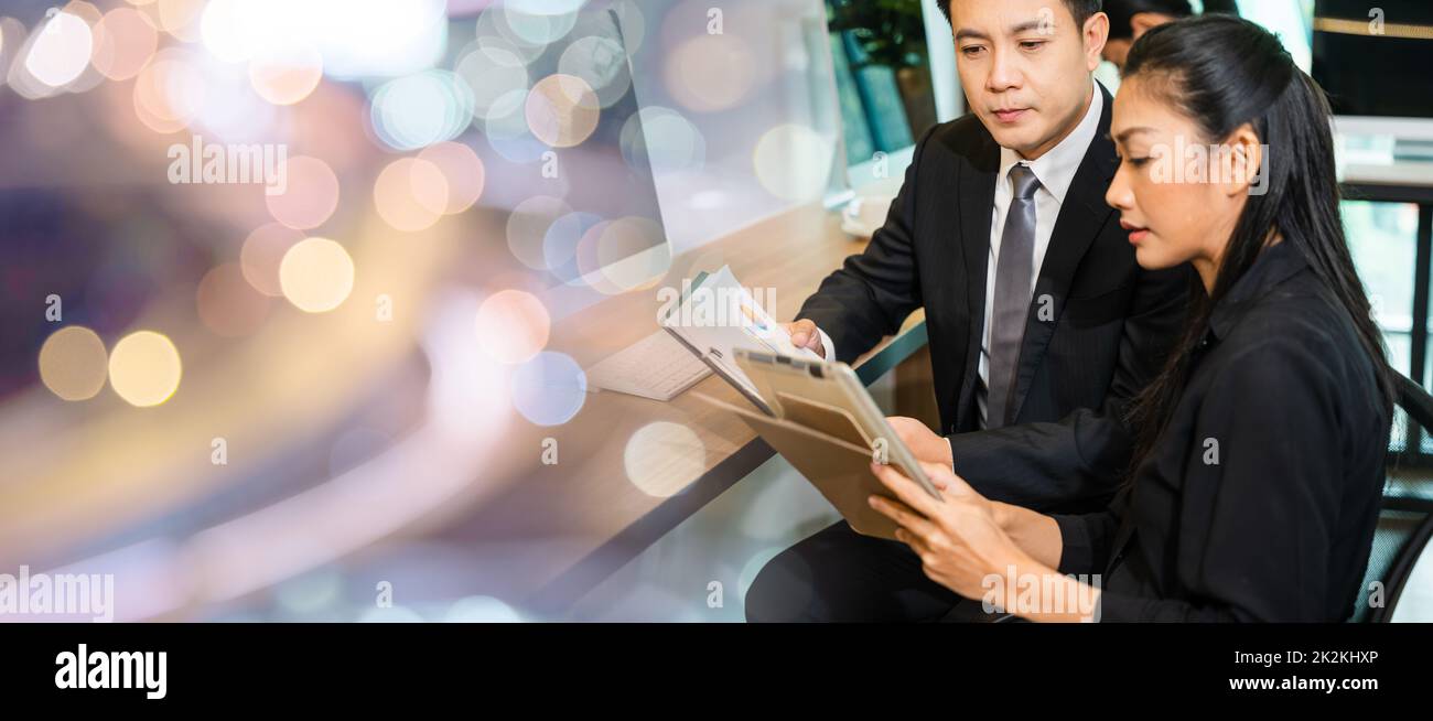 Two business people having meeting together discussing the charts and ...