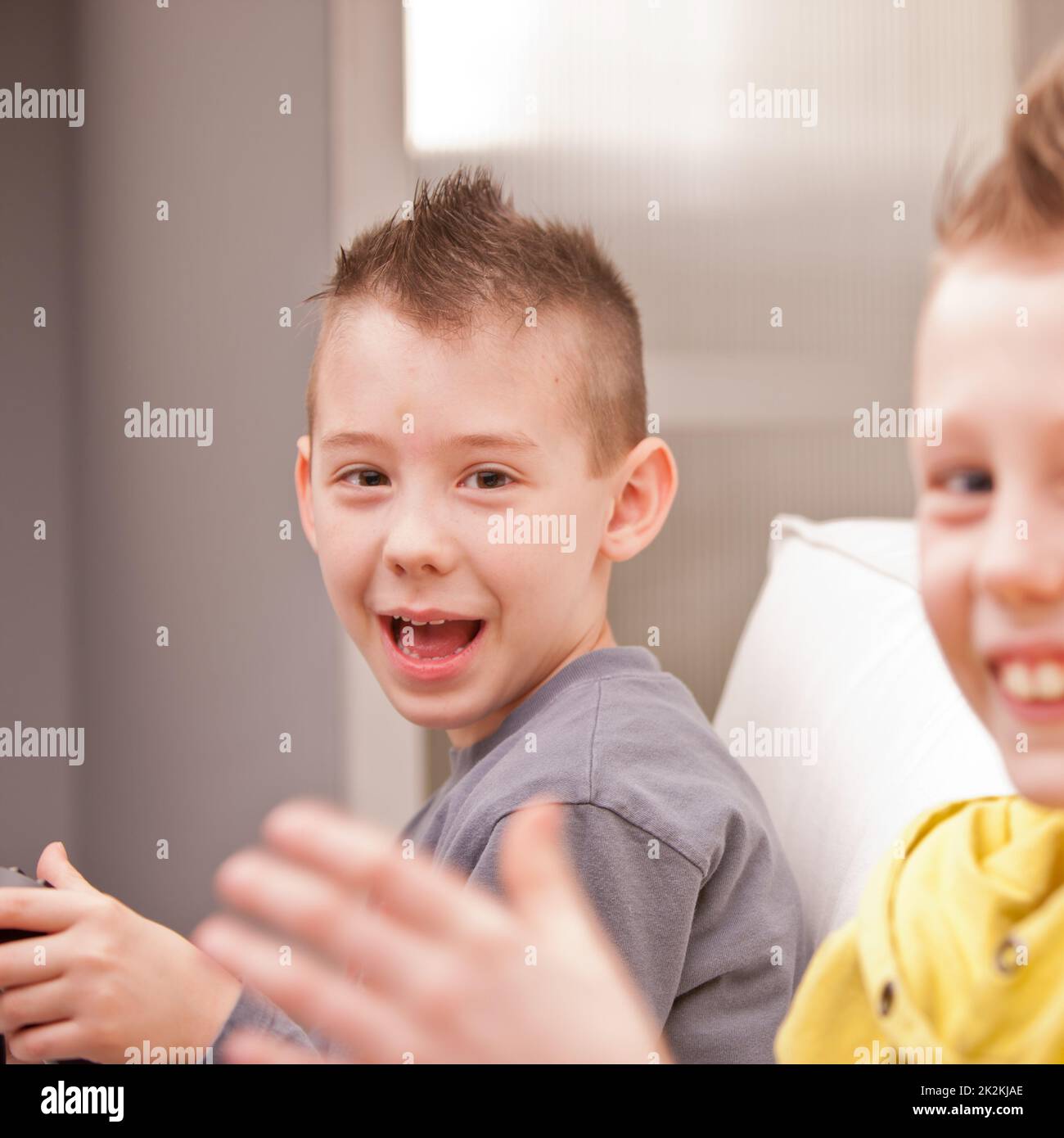 little boy smiling at camera with his friend Stock Photo - Alamy