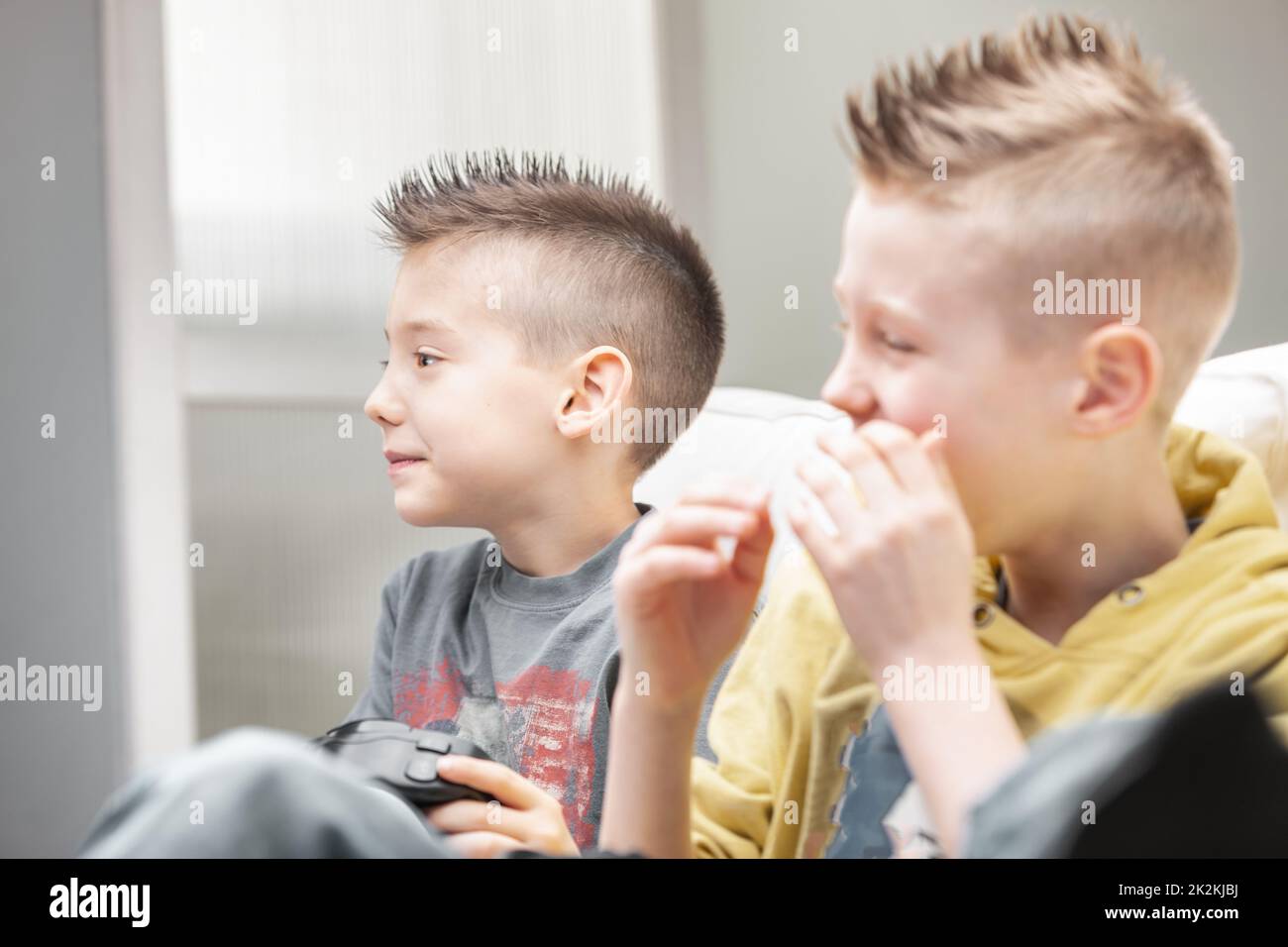 Young boy looking at his video game with disappointed expression Stock ...