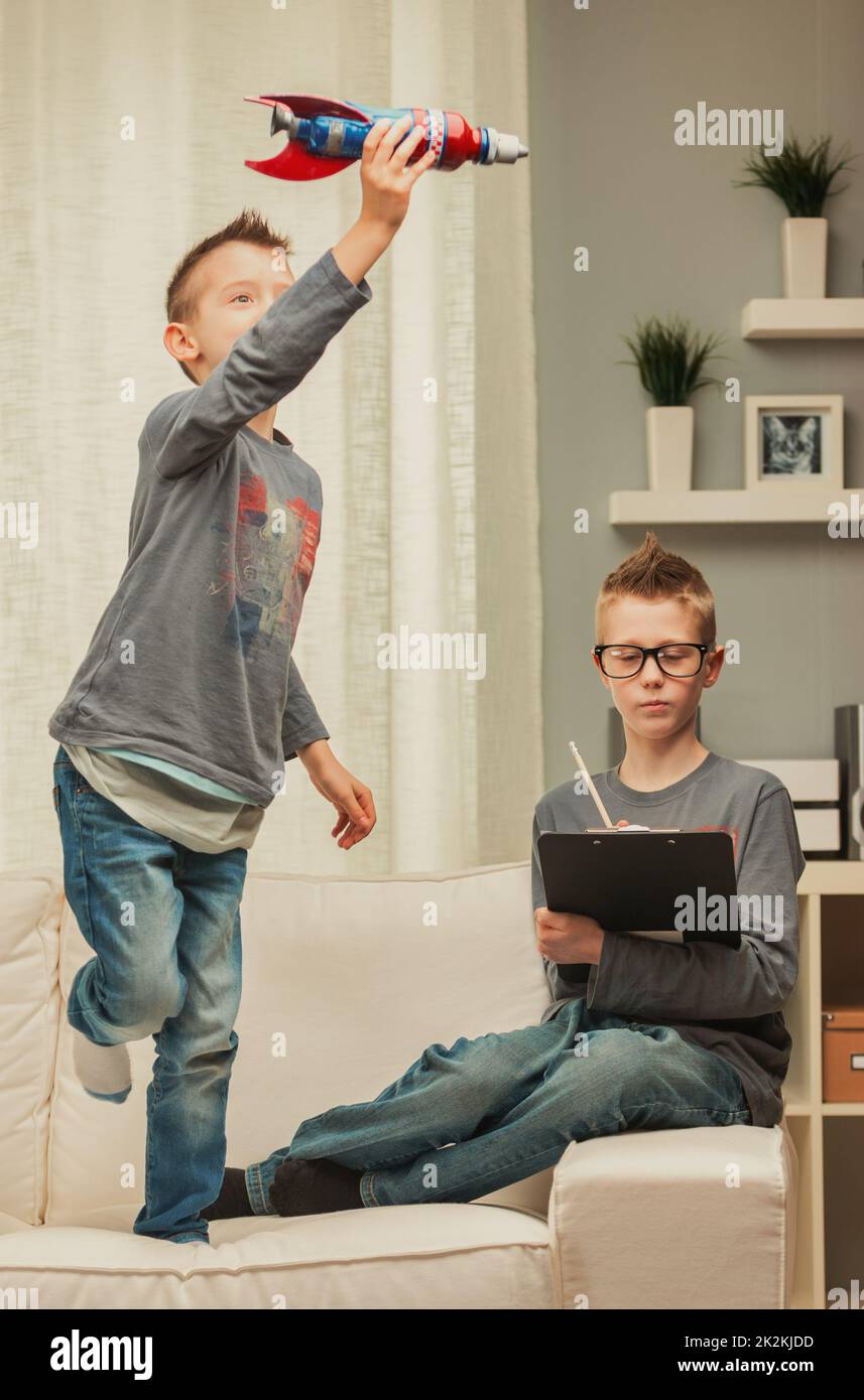 Happy young boy playing with his toy rocket Stock Photo - Alamy