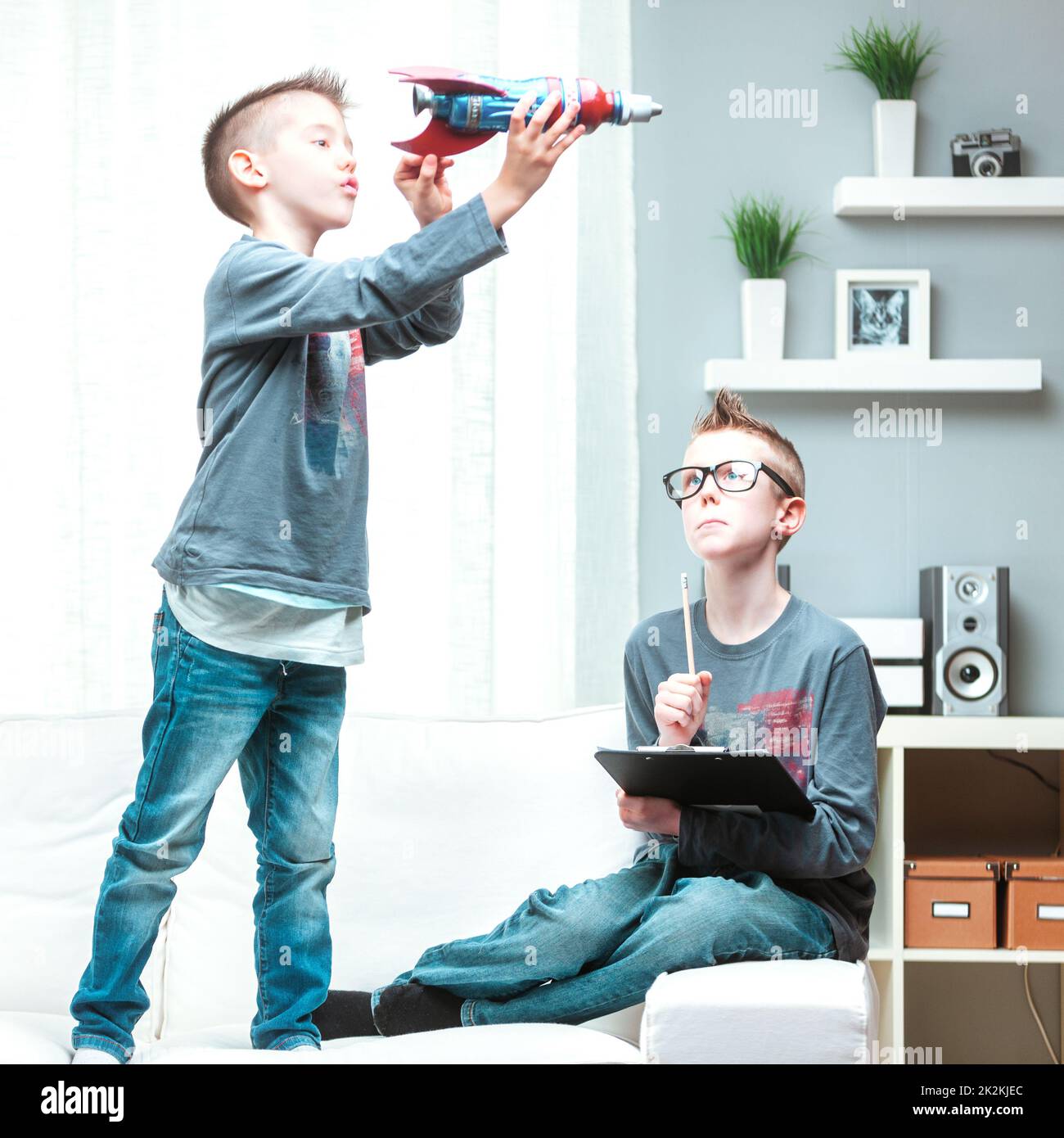 Active young boy playing with his toy spacecraft Stock Photo - Alamy