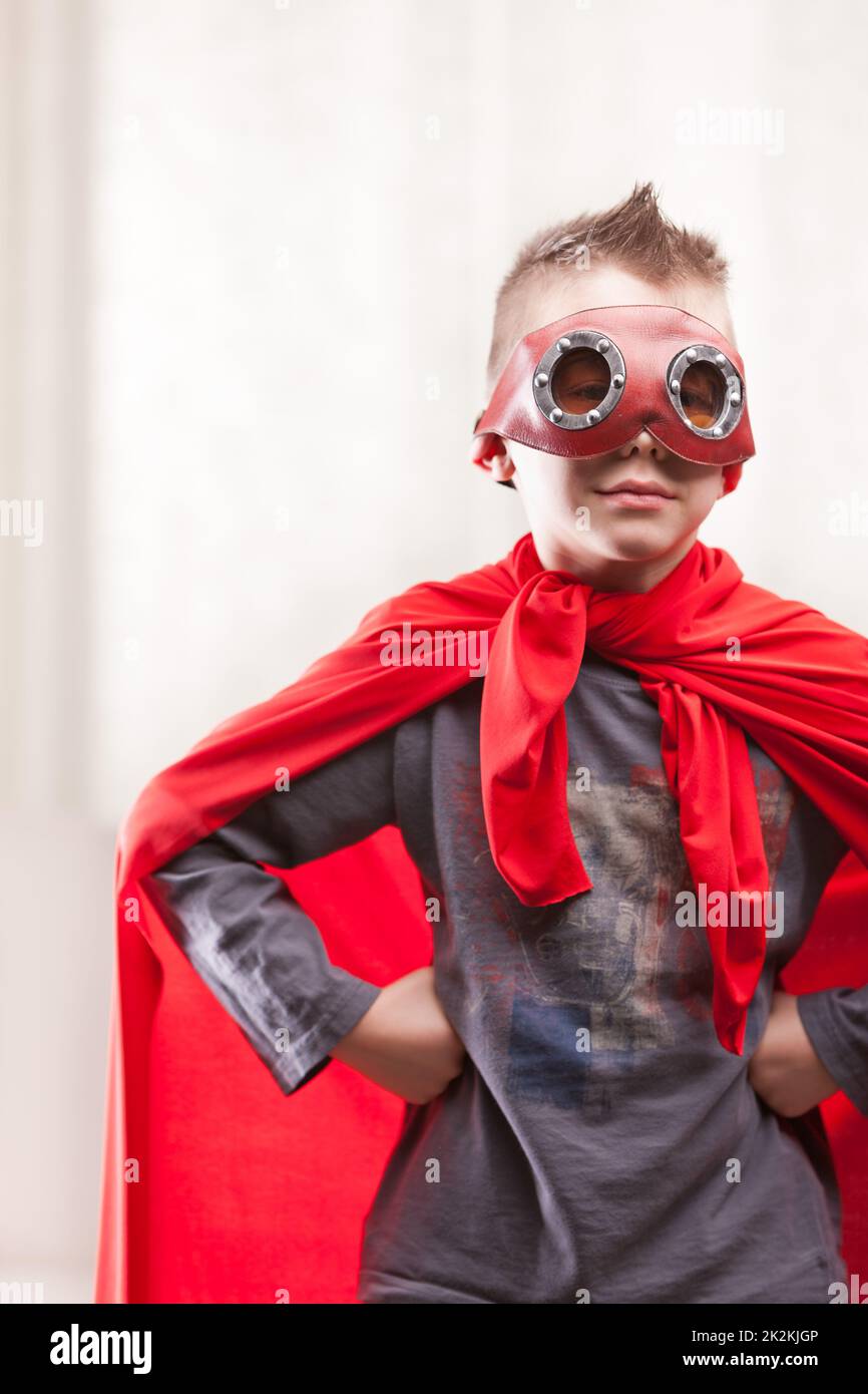 red cloak kid livingroom superhero Stock Photo - Alamy