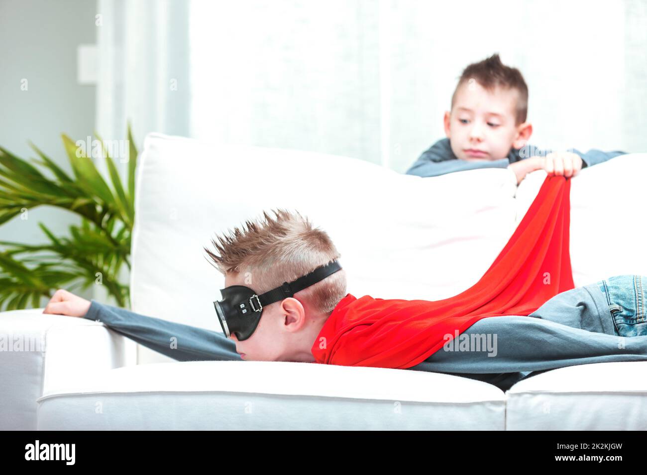 Young boy wth cute spiky hairstyle playing Super Hero Stock Photo - Alamy