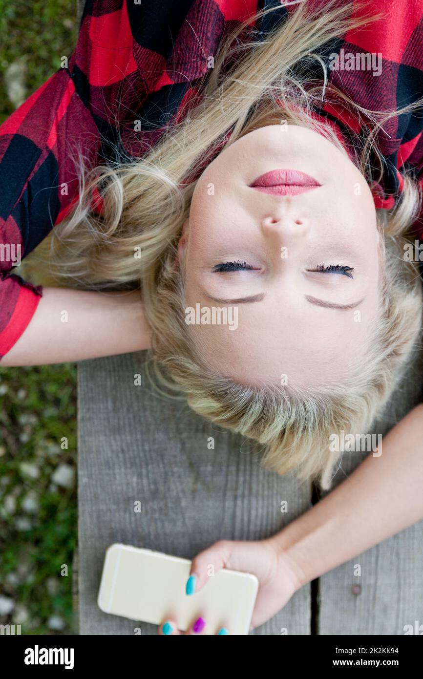 woman sleeping on the bench of a park Stock Photo - Alamy