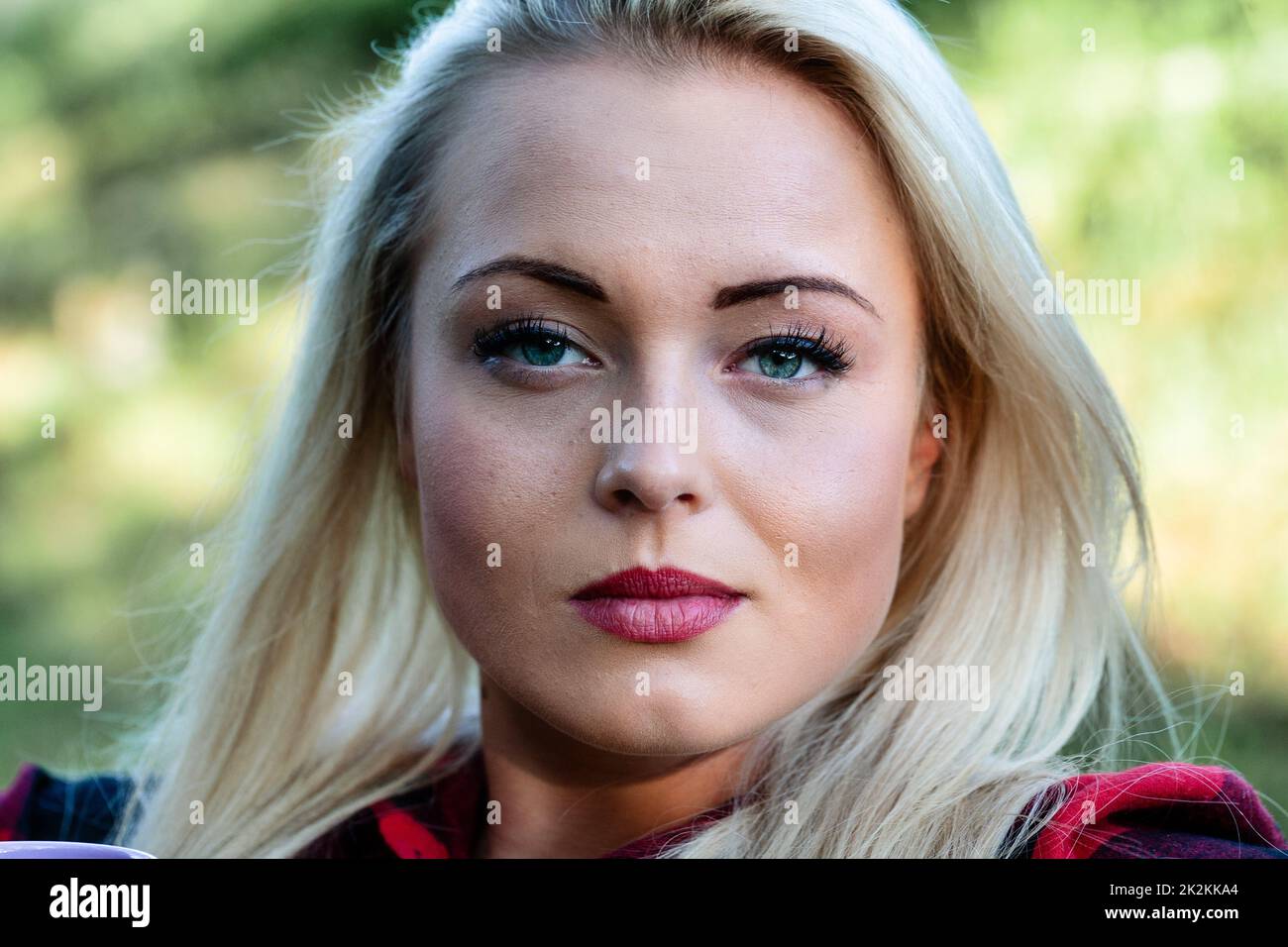 Beautiful serious young woman with a serene expression Stock Photo - Alamy