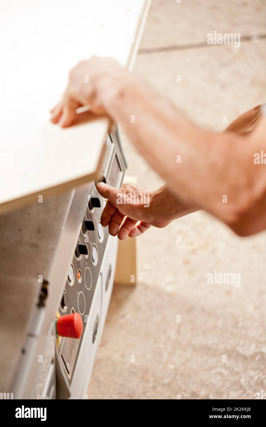 carpenter's hand on control knobs Stock Photo - Alamy