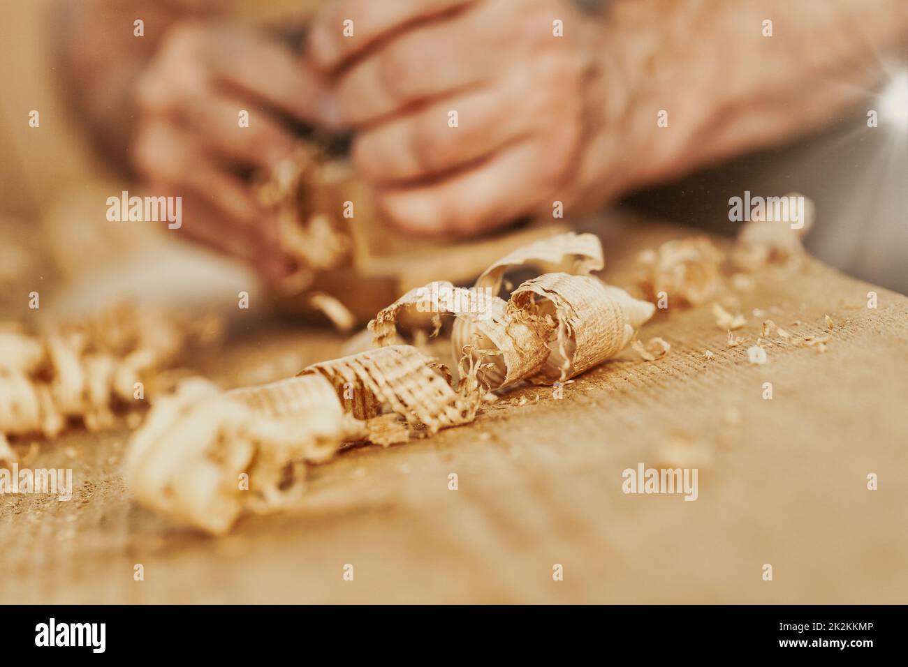 Coils of fresh wood shavings on a woodworking workbench Stock Photo - Alamy