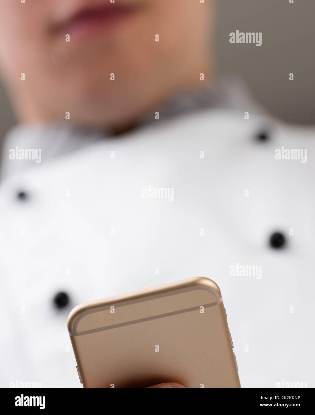 young chef ordering online with his smartphone Stock Photo - Alamy