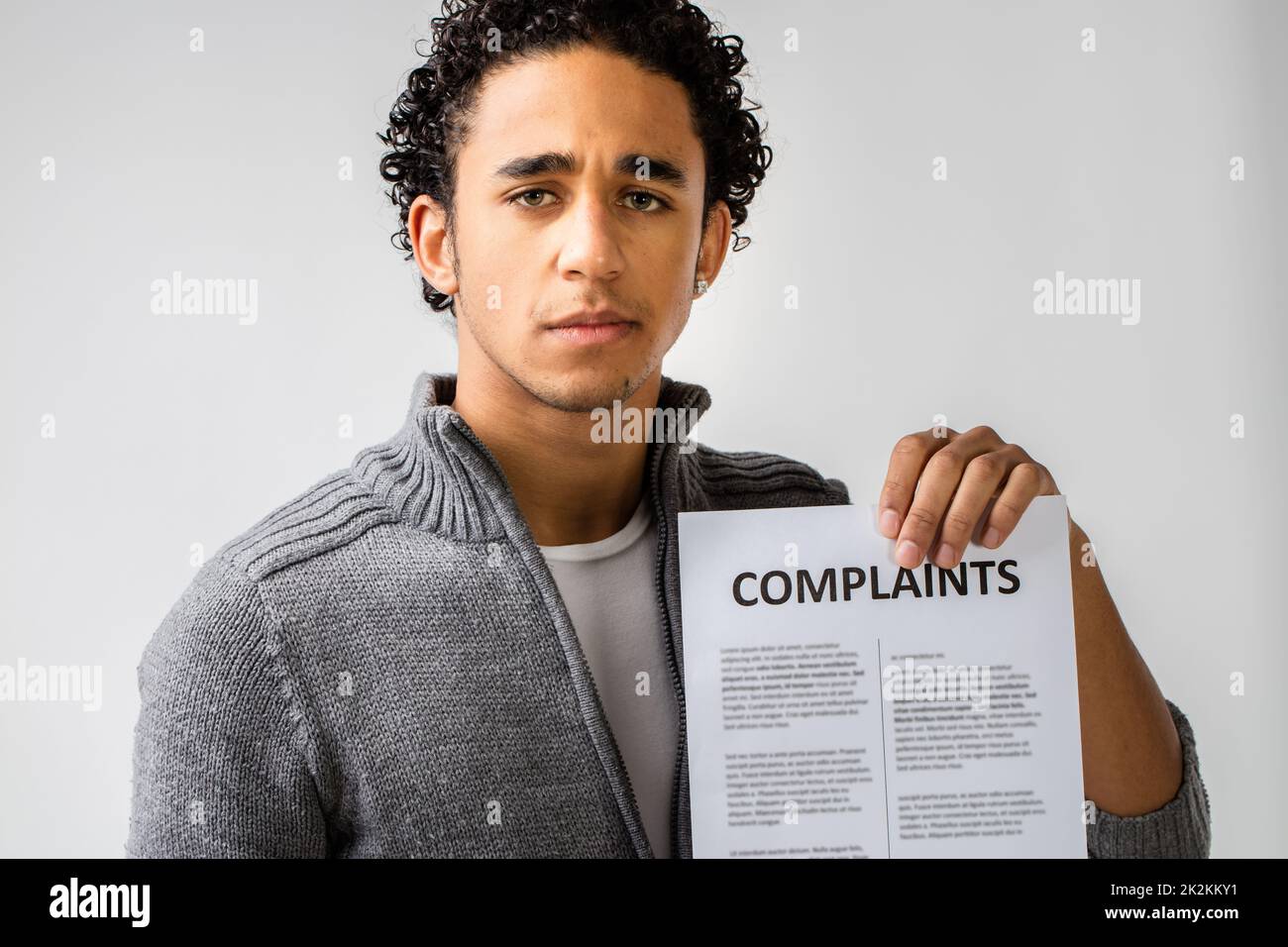 young man holding complaints report Stock Photo - Alamy