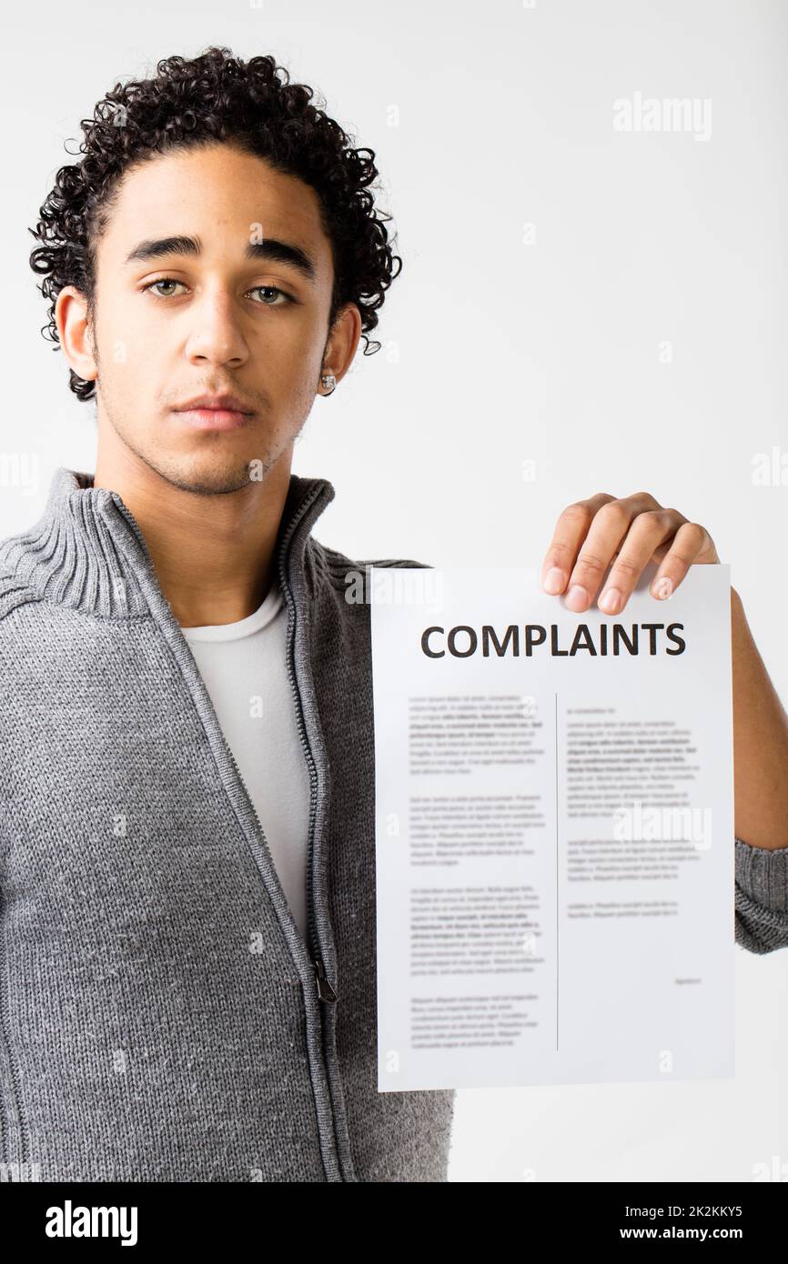 young man holding complaints report Stock Photo - Alamy