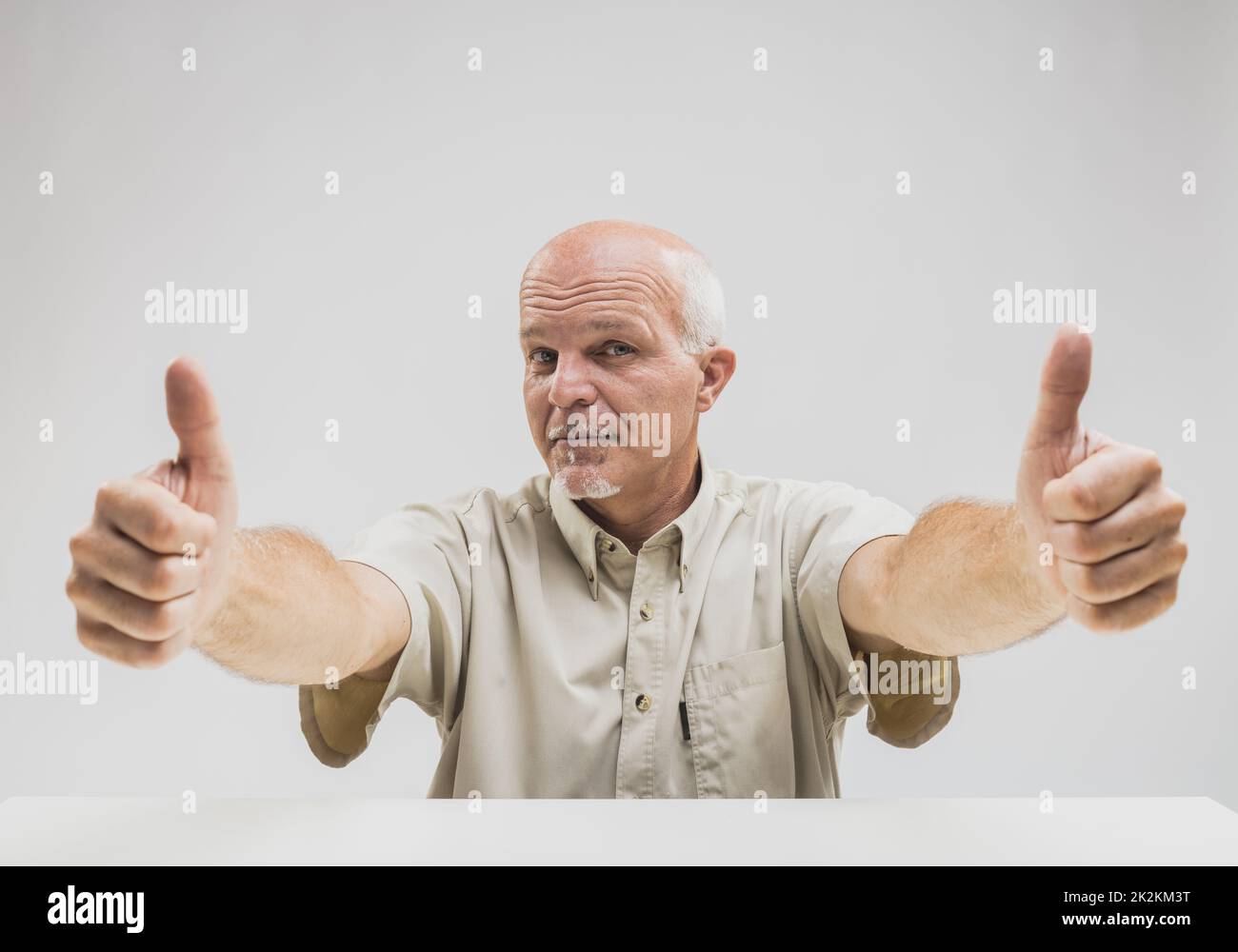 Positive senior man giving a double thumbs up Stock Photo - Alamy