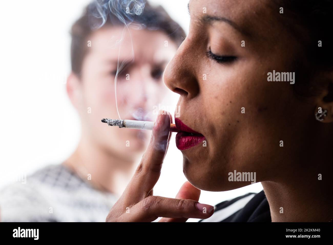 woman smoking a cigarette and disappointed man Stock Photo - Alamy