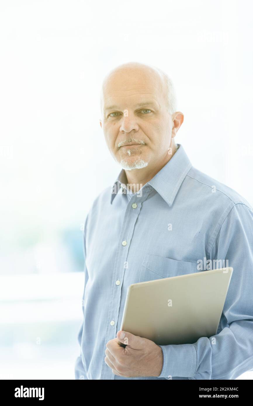 Thoughtful senior businessman staring intently at the camera Stock ...