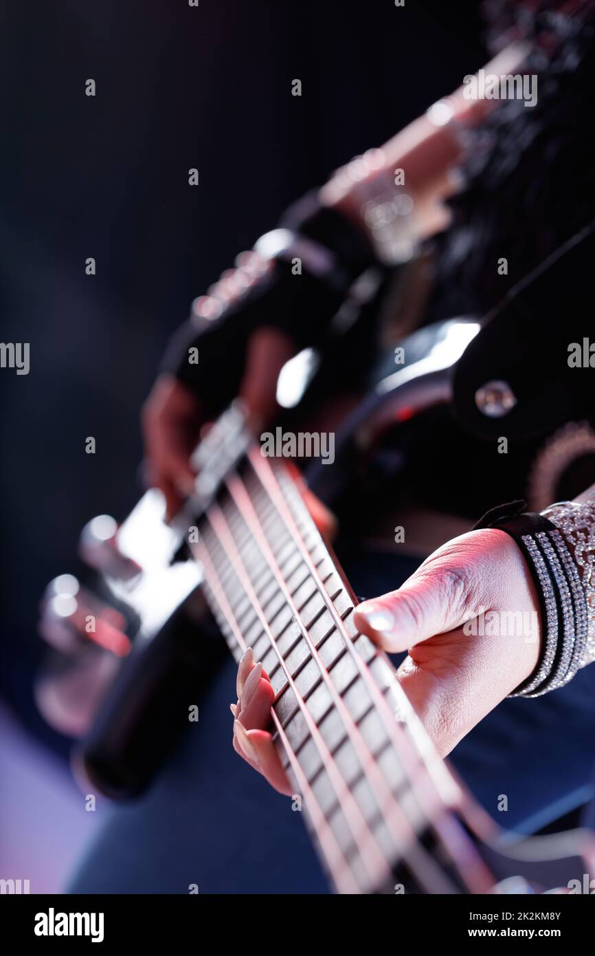 Female musician playing electric guitar during a performance Stock ...