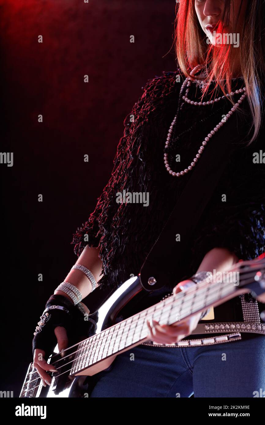 Closeup on a young female guitarist playing electric guitar Stock Photo ...