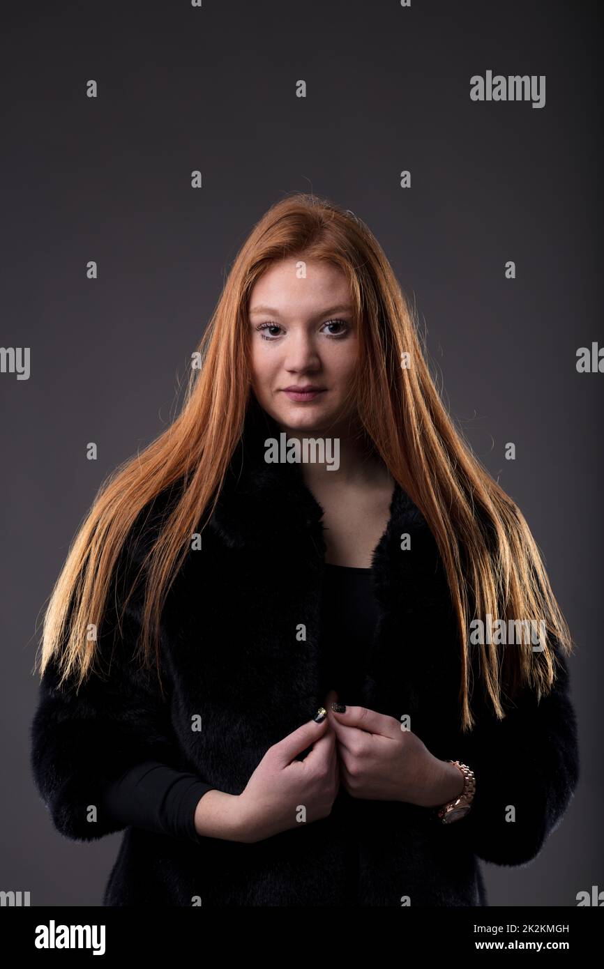 red haired woman on a black fur coat Stock Photo - Alamy